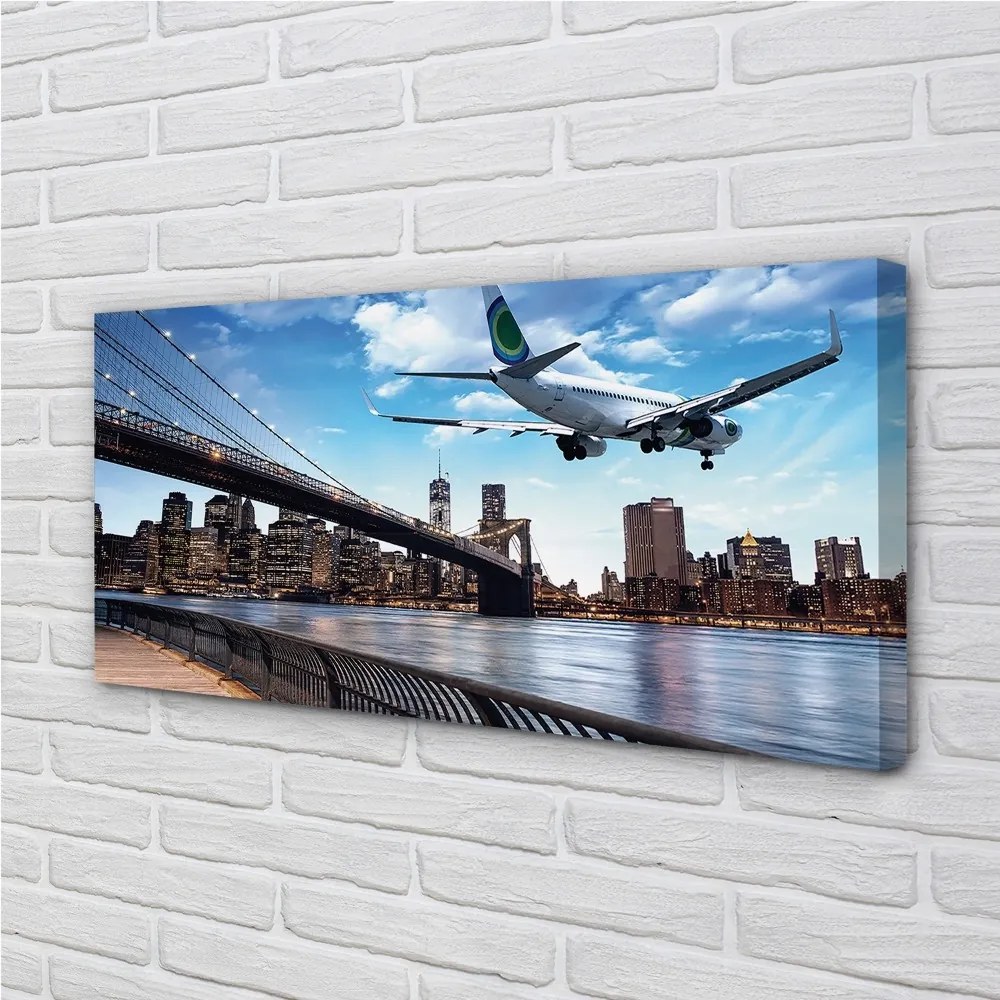 Obrazy na plátně Letadel mraky město 140x70 cm
