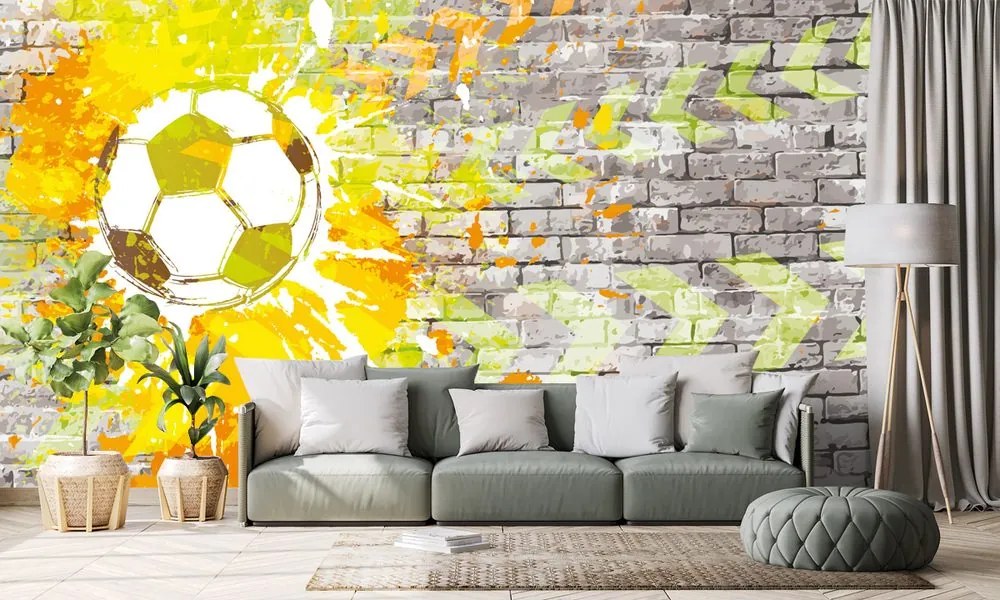 Samolepící tapeta fotbalový míč na cihlové zdi