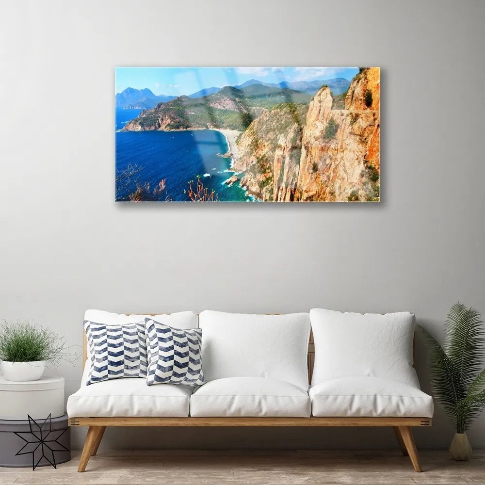 Obraz na skle Útes Pobřeží Moře Hory 140x70 cm