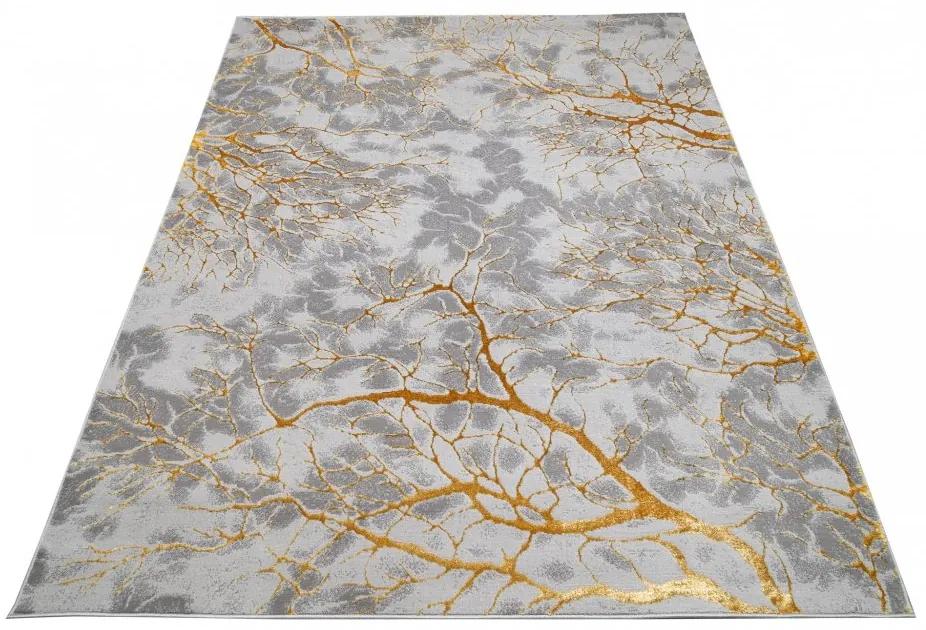 Jednoduchý moderní koberec v šedé barvě se zlatým motivem Šířka: 120 cm | Délka: 170 cm