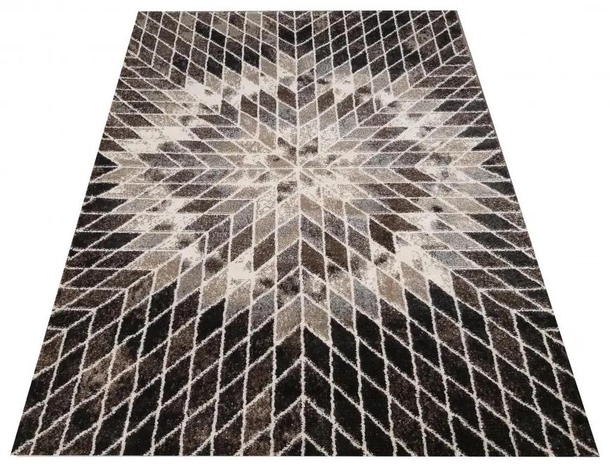 Hnědý vzorovaný koberec a abstraktním motivem Šířka: 80 cm | Délka: 150 cm