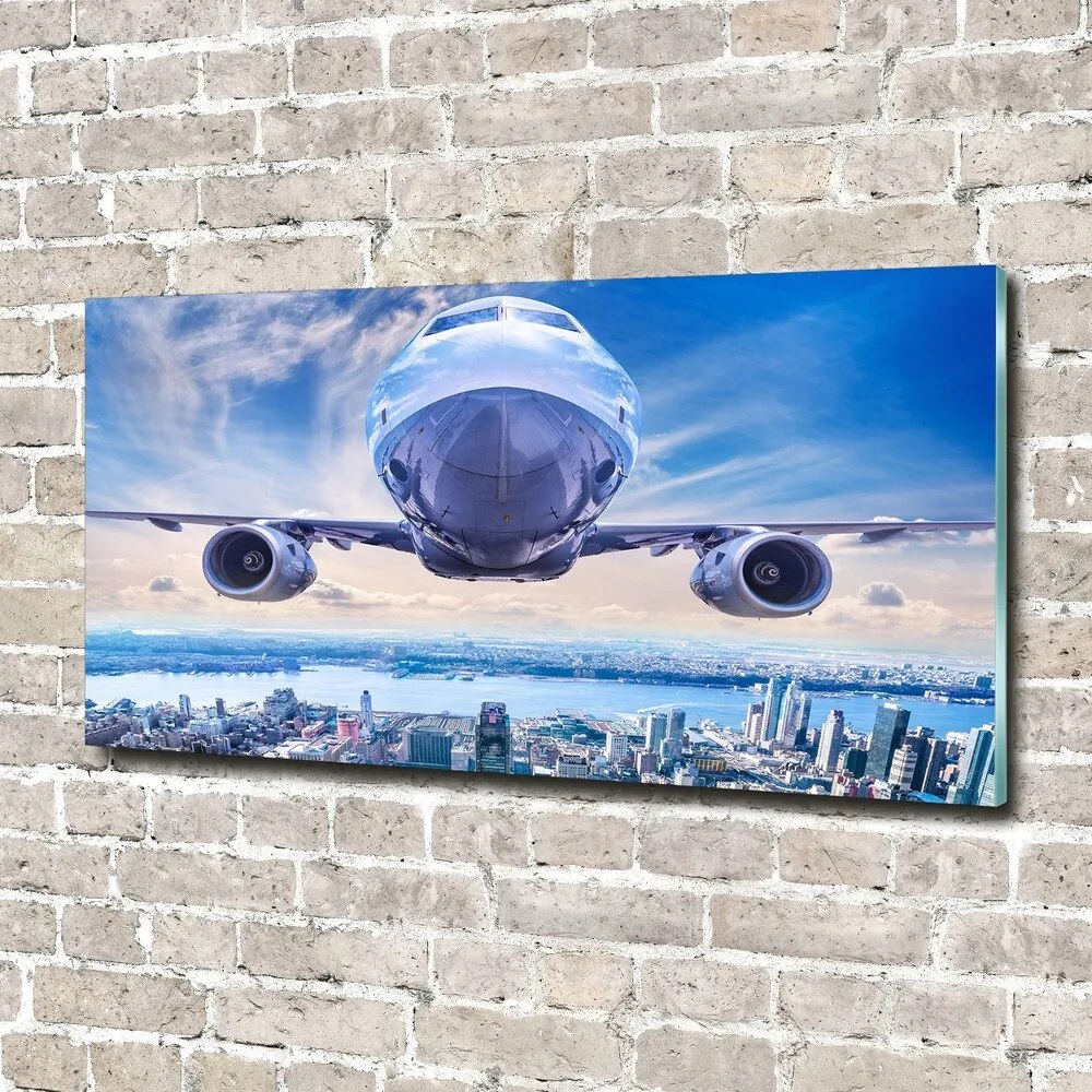 Wallmuralia Moderní skleněný obraz z fotografie Letadlo na městem 140x70 cm