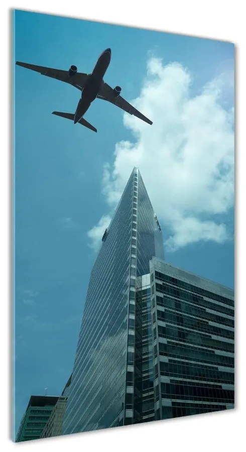 Wallmuralia Vertikální Fotoobraz na skle Letadlo nad městem 50x100