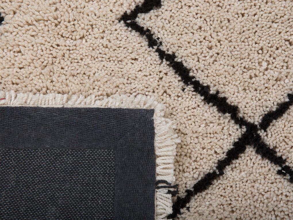 Béžový koberec s černým vzorem 140 x 200 cm HAVSA Beliani