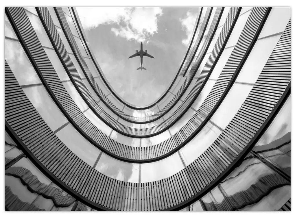 Skleněný obraz - Letadlo nad budovou (70x50 cm)