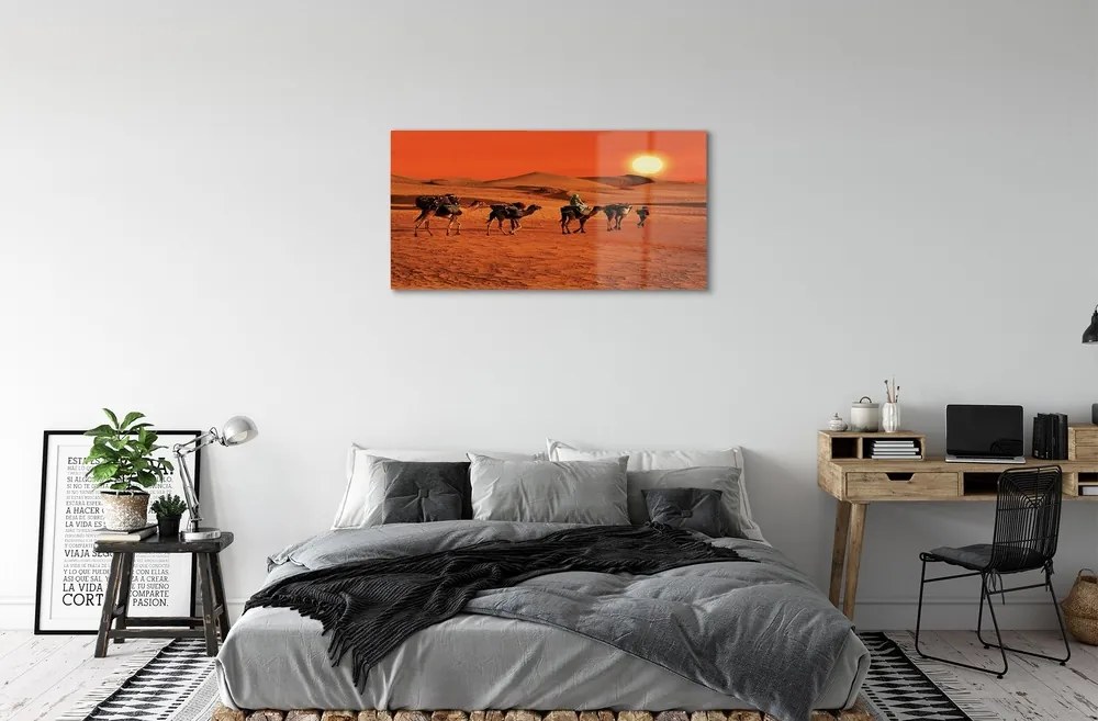 Obraz na skle Velbloudi lidí pouštní slunce nebe 100x50 cm