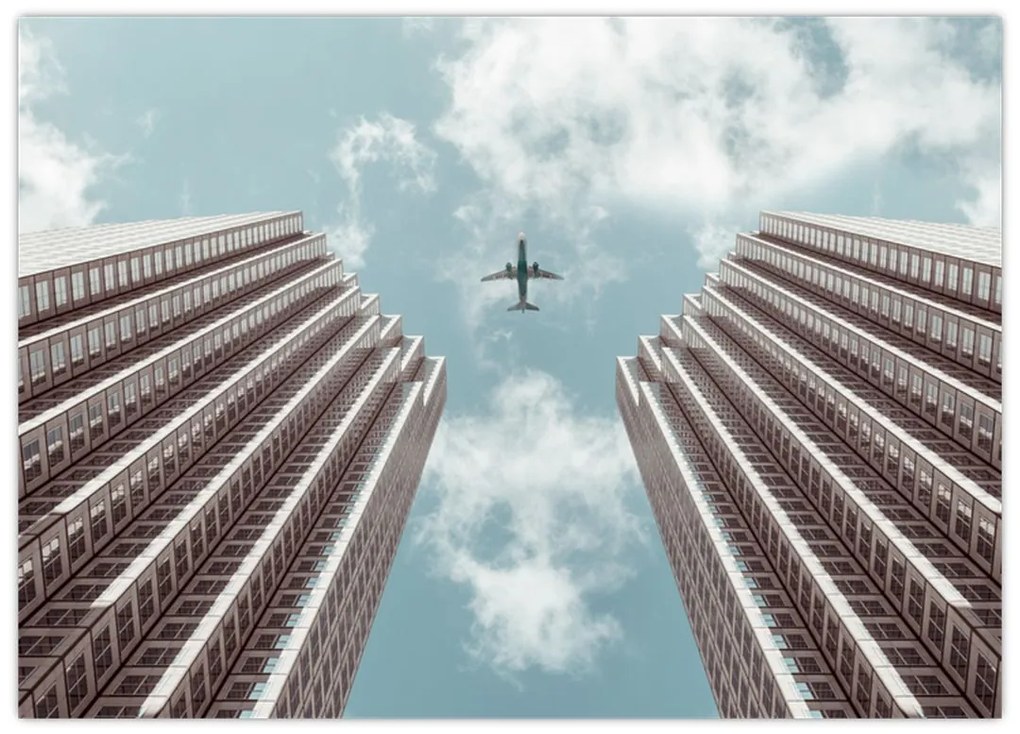 Obraz letadla mezi budovami (70x50 cm)