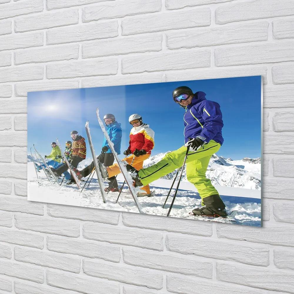 Obraz na skle Lyžaři zimní hory 125x50 cm