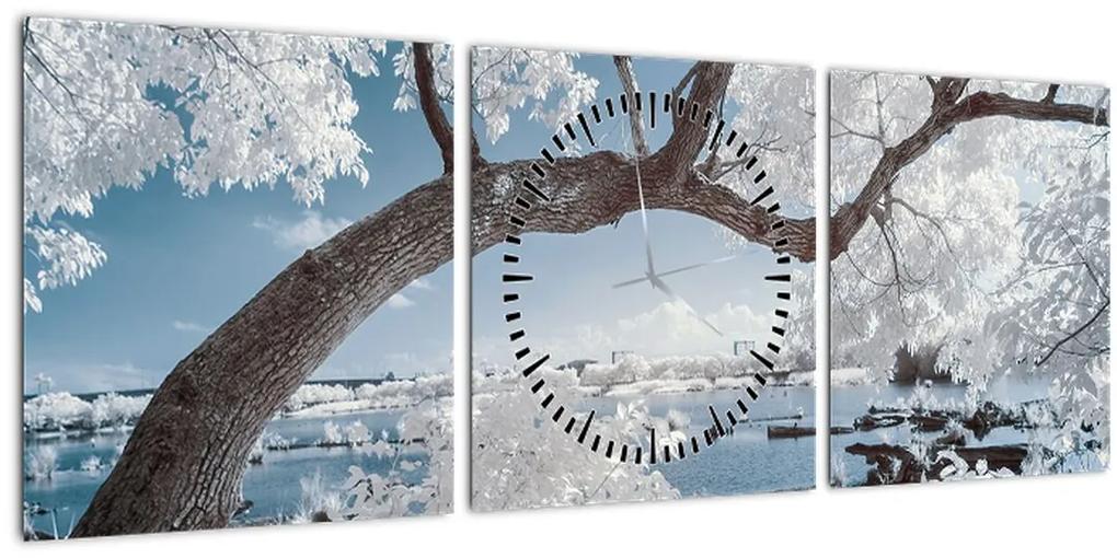 Obraz zasněženého stromu u vody (s hodinami) (90x30 cm)
