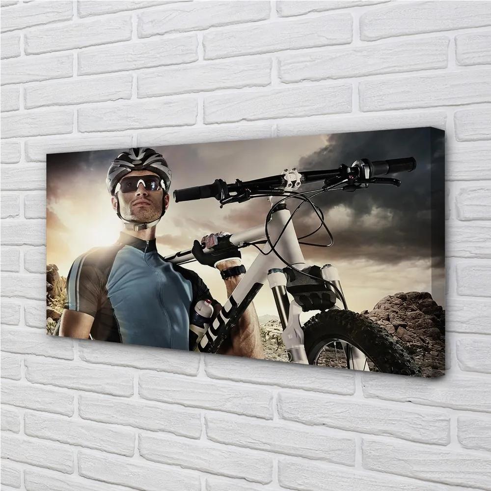 Obrazy na plátně Cyklista na kole mraky 125x50 cm
