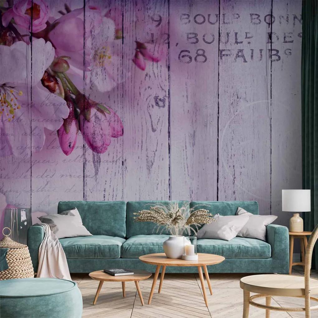 Fototapeta Květy jabloně - motiv v odstínech fialové na pozadí s texturou dřeva