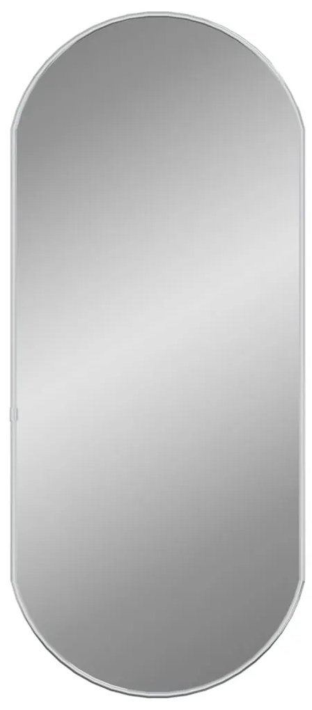 vidaXL Nástěnné zrcadlo stříbrné 70x30 cm oválné