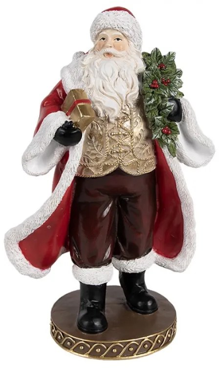 Červená vánoční dekorace Santa Claus na hnědém podstavci držící dárek a vánoční bobule – 23 cm