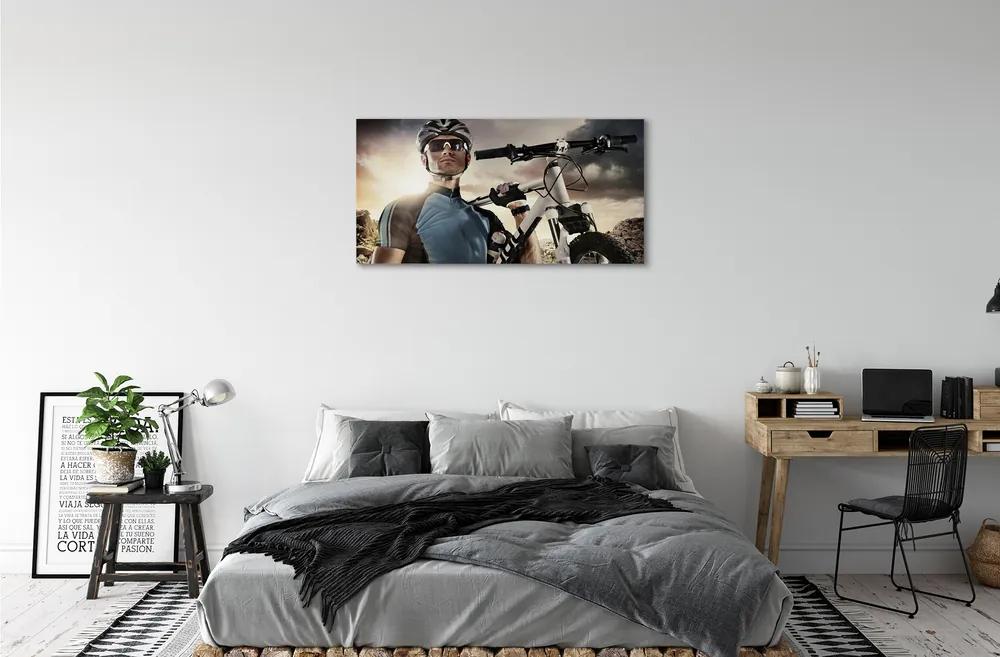 Obrazy na plátně Cyklista na kole mraky 125x50 cm