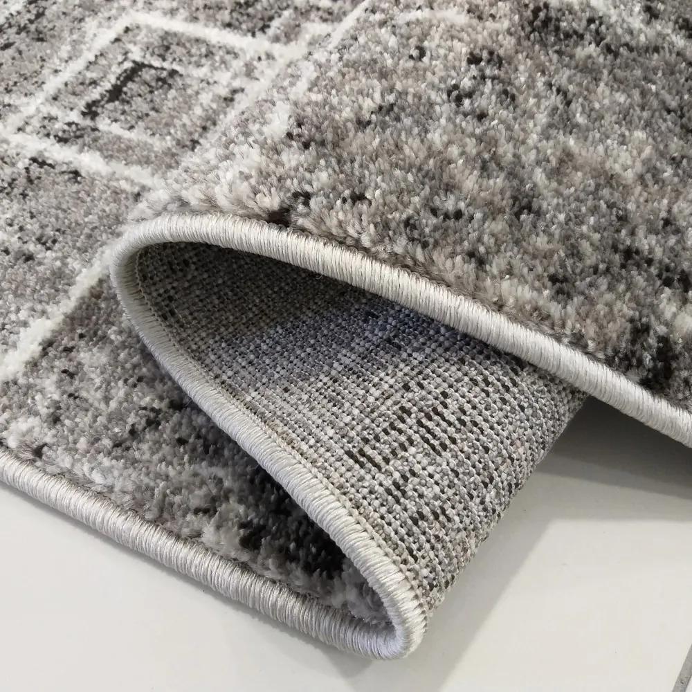 Moderní koberec šedé barvy s abstraktním motivem Šířka: 120 cm | Délka: 170 cm