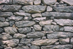 DIMEX | Samolepicí vliesová fototapeta na zeď Hrubá kamenná zeď MA-5-2396 | 375 x 250 cm | černá, šedá