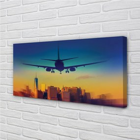 Obrazy na plátně Velkoměsto oblačnosti letadlo západ 140x70 cm