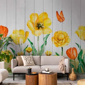 Fototapeta Tulipány na louce - žluté květiny na pozadí bílých dřevěných desek