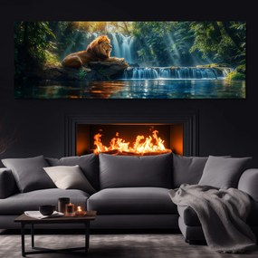 Obraz na plátně - Lev odpočívá u vodopádu v džungli FeelHappy.cz Velikost obrazu: 150 x 50 cm