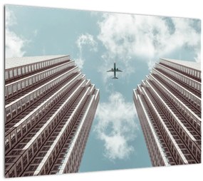 Obraz letadla mezi budovami (70x50 cm)