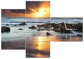 Gario Obraz s hodinami Západ slunce nad oceánem - 3 dílný Rozměry: 100 x 70 cm