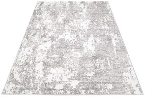 Designový koberec s abstraktním vzorem v krémové barvě