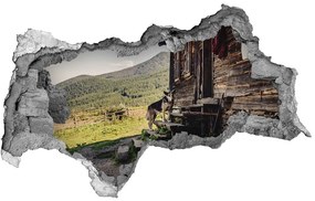Wallmuralia Díra 3D ve zdi nálepka Dřevěný dům hory 95x73 cm