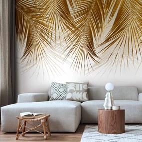 Fototapeta Pod tropickou rostlinou - rozložité větve palmy se zlatými listy