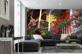 DIMEX | Samolepicí vliesová fototapeta na zeď Balkon s květinami MA-5-0789 | 375 x 250 cm | zelená, vícebarevná, růžová