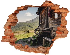 Wallmuralia Díra 3D ve zdi nálepka Dřevěný dům hory 90x70 cm