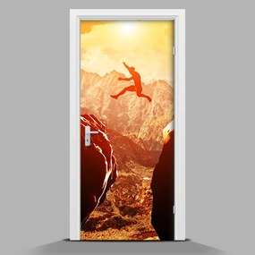 Wallmuralia Samolepící nálepka na dveře Skok přes hory 75x205