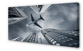 Obrazy na plátně Velkoměsto oblačnosti letoun nebe 100x50 cm